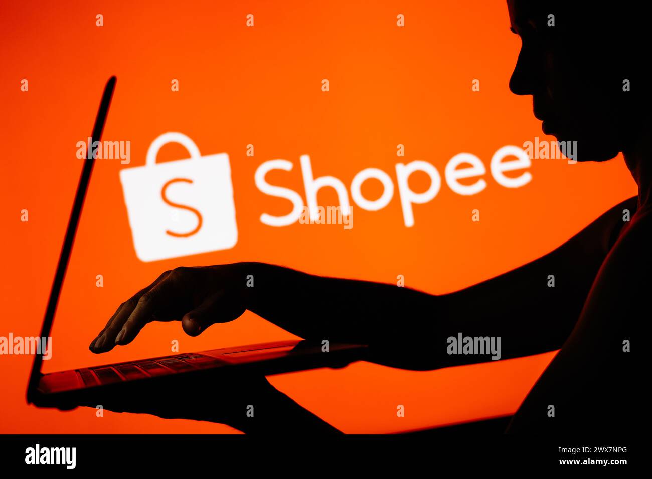 In this photo illustration, the Shopee logo is seen in the background ...