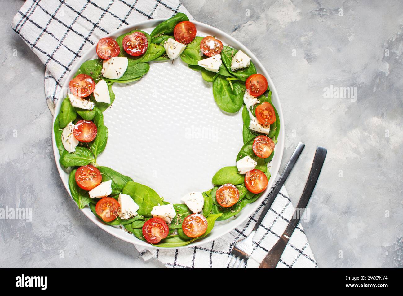Italian caprese salad with tomatoes, mozzarella, basil, olive oil on a ...