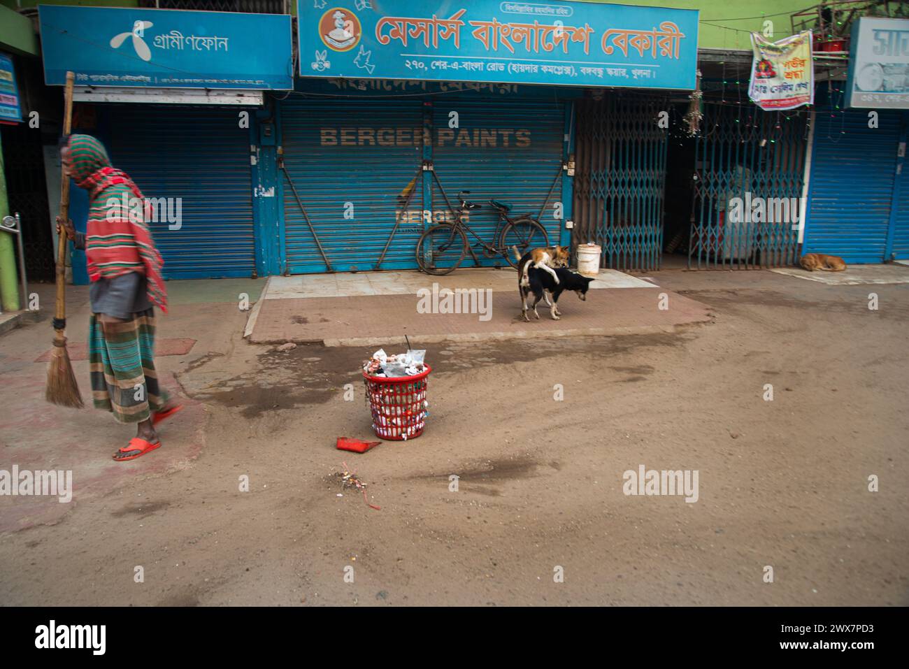A cleaning worker of the city corporation, is seen sweeping the streets ...
