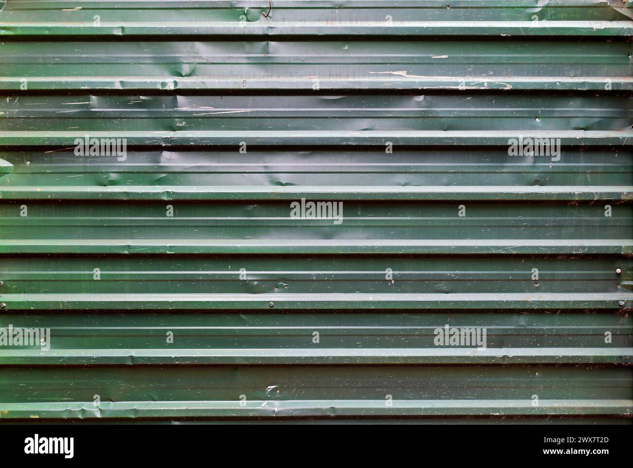 Green corrugated metal plate surrounding wasteland Stock Photo - Alamy