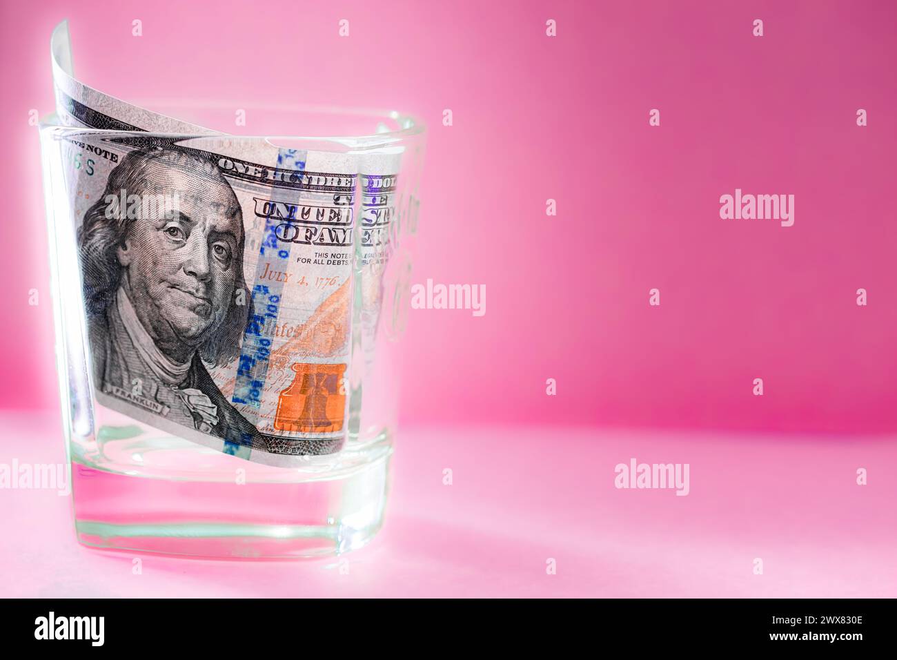 100 dollar bill in whiskey glass for design purpose Stock Photo - Alamy