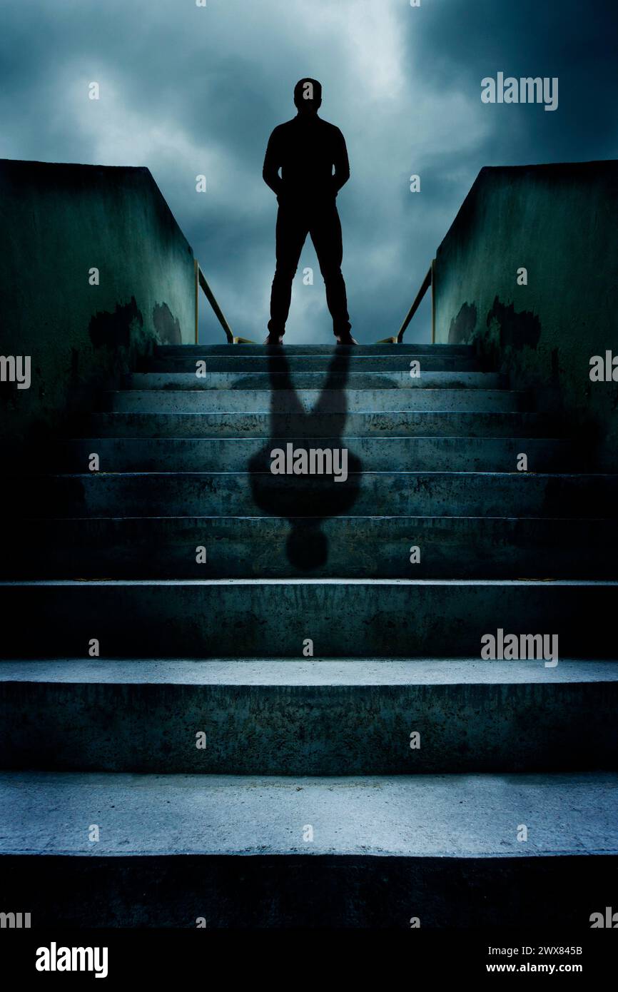 mysterious man standing on top of a staircase with dramatic sky, dark ...