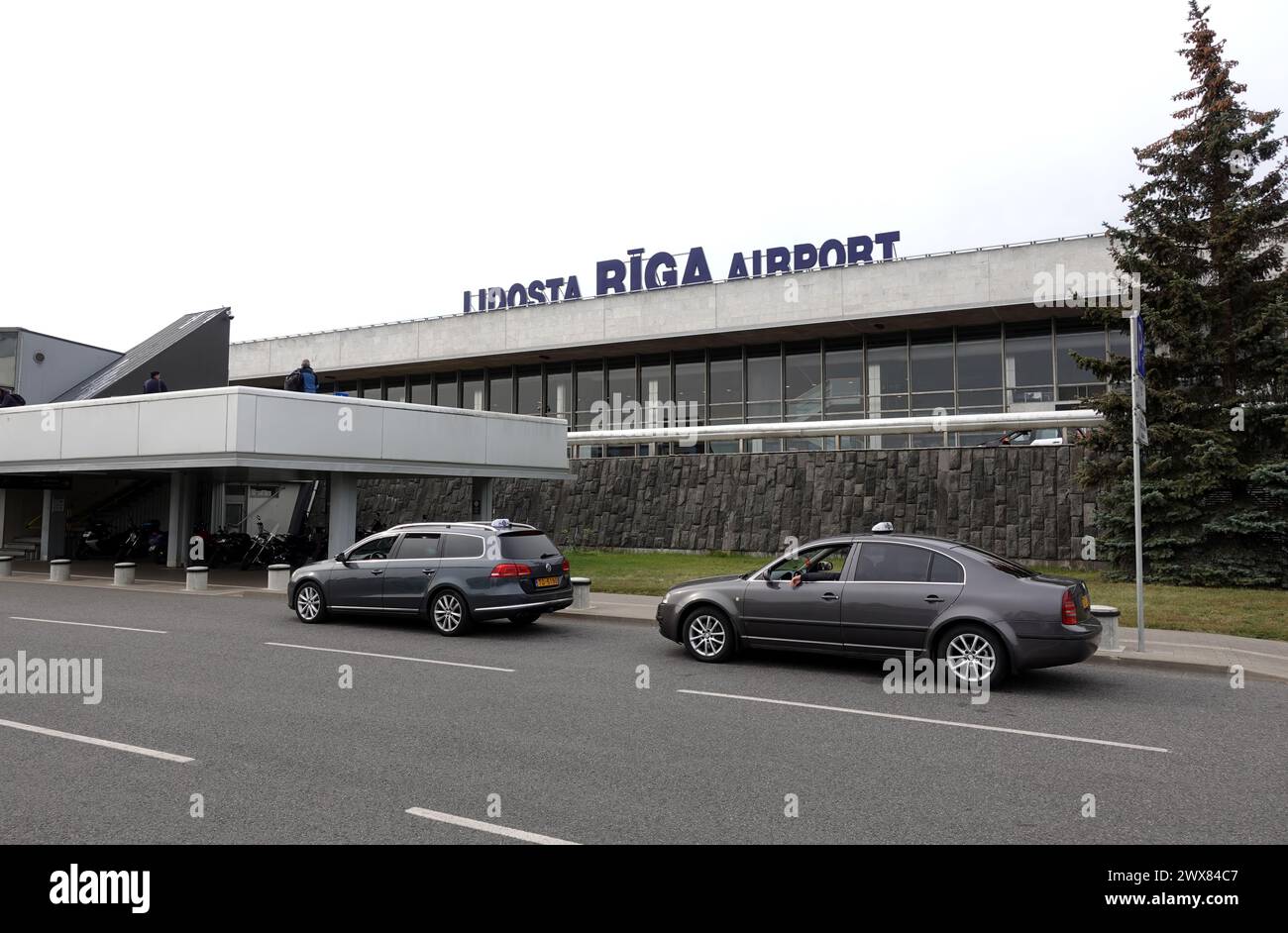 Building of Riga international airport with parked taxi cars in front ...