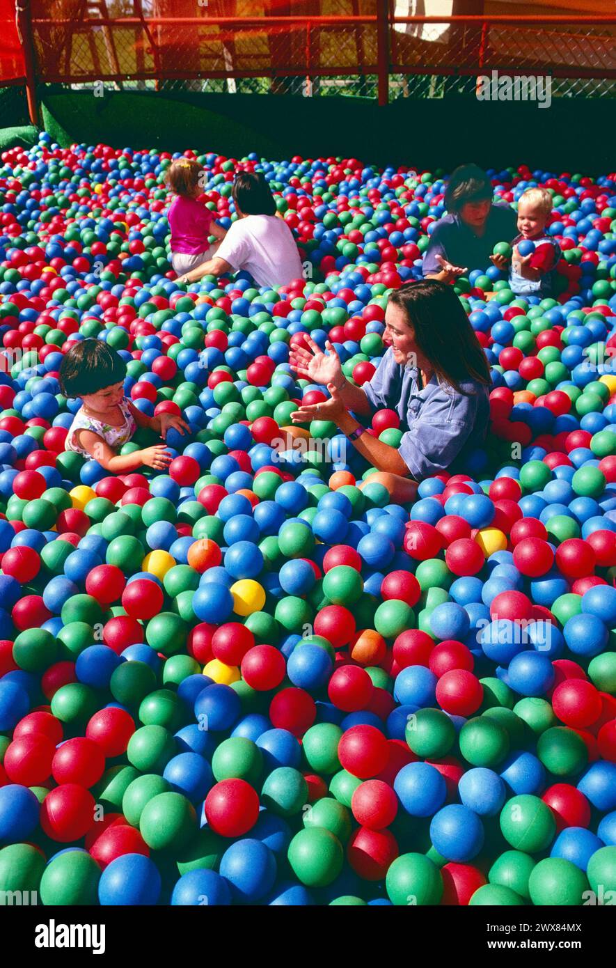 Children & adults playing in the "Snuffleballs" at Sesame Place, a ...