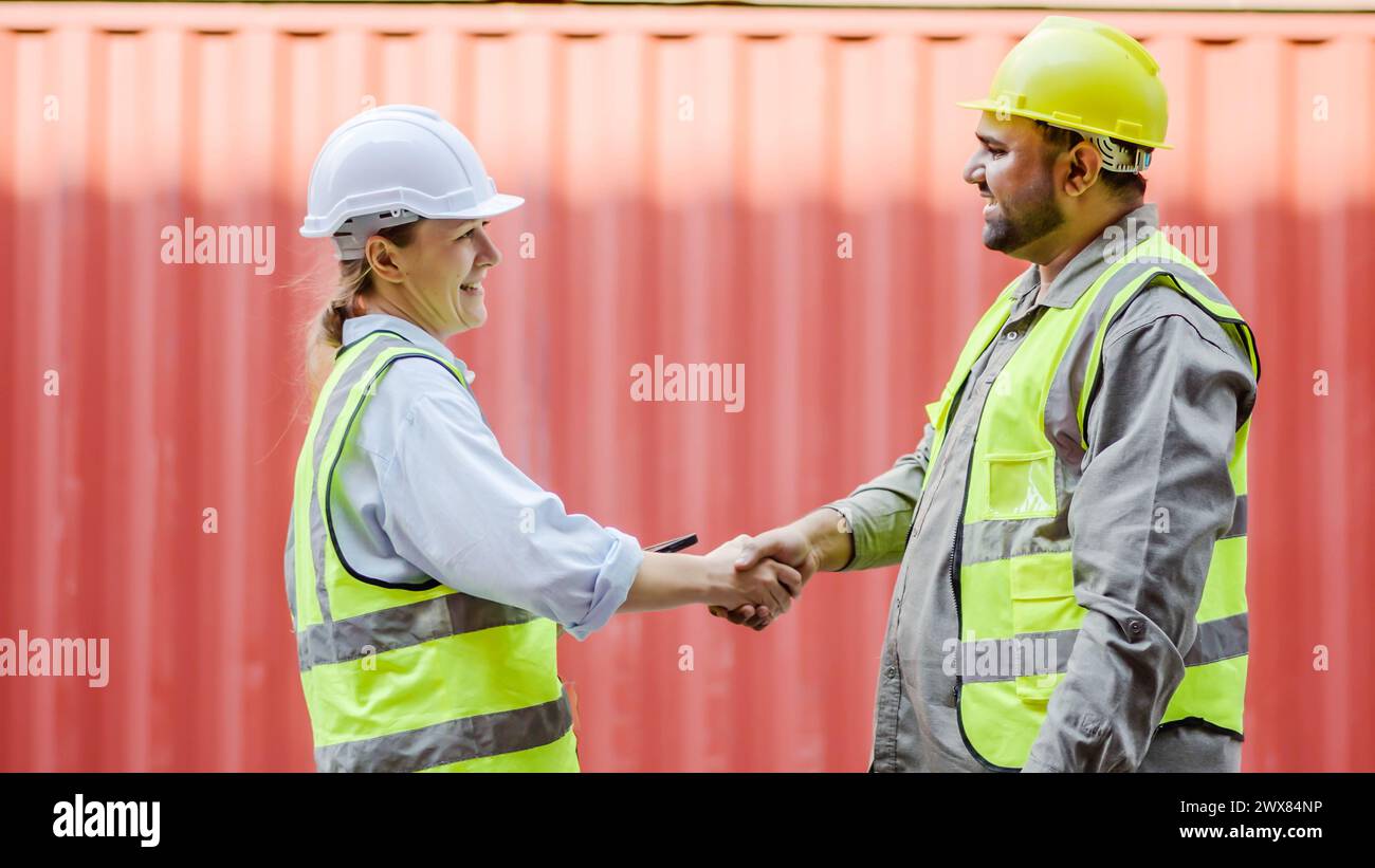 A handshake in front of a cargo container facility Stock Photo - Alamy
