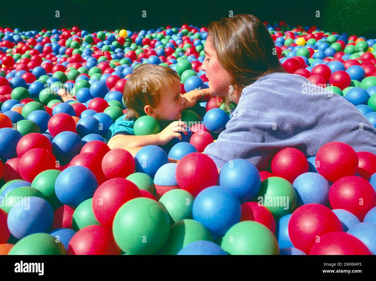 Children & adults playing in the "Snuffleballs" at Sesame Place, a ...