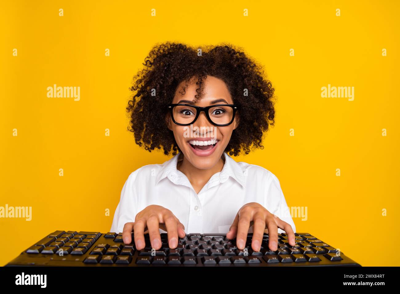 Portrait of attractive cheerful wavy-haired girl typing playinggame ...