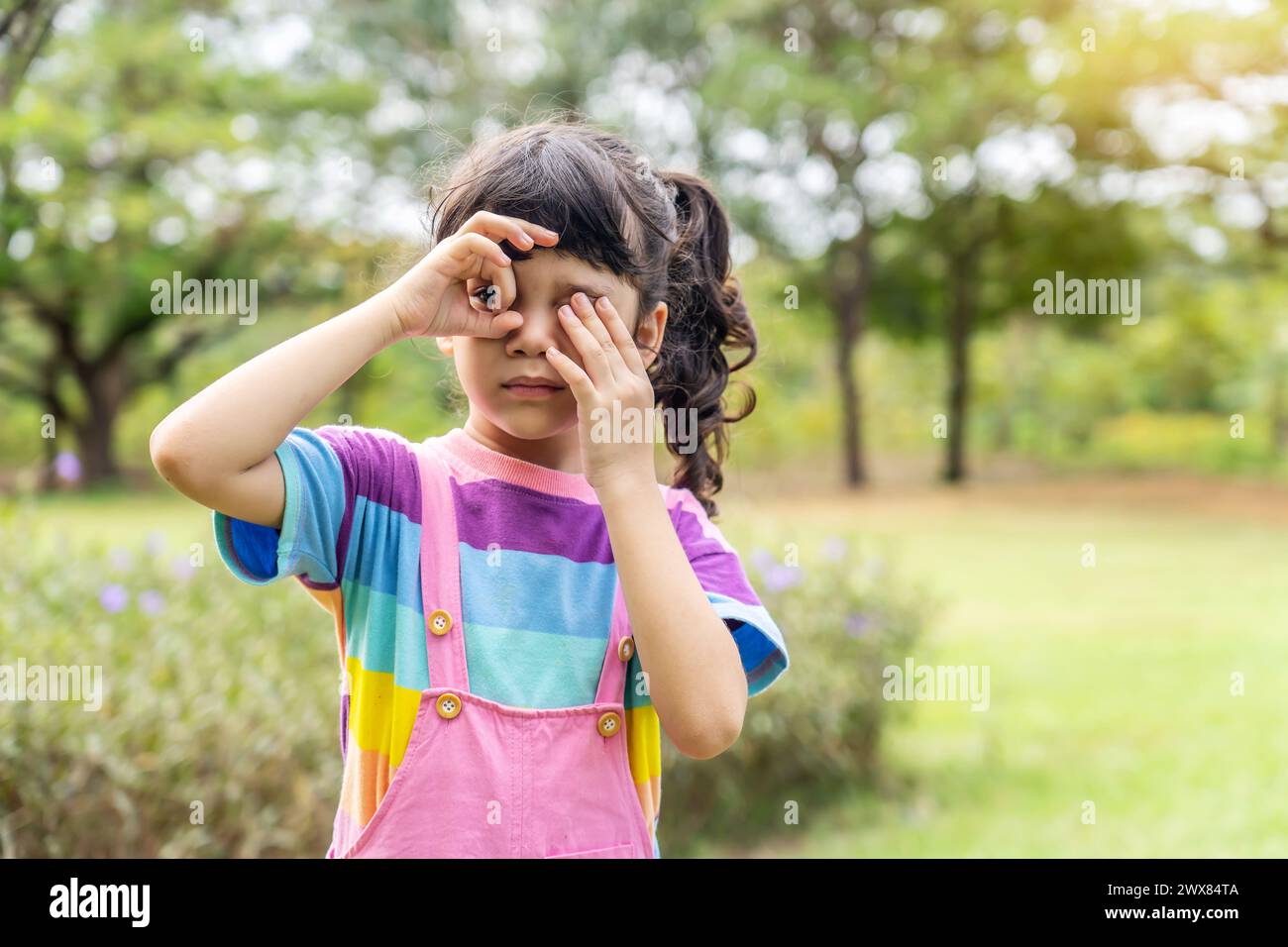 A young child shielding their eyes while gazing into the distance Stock ...