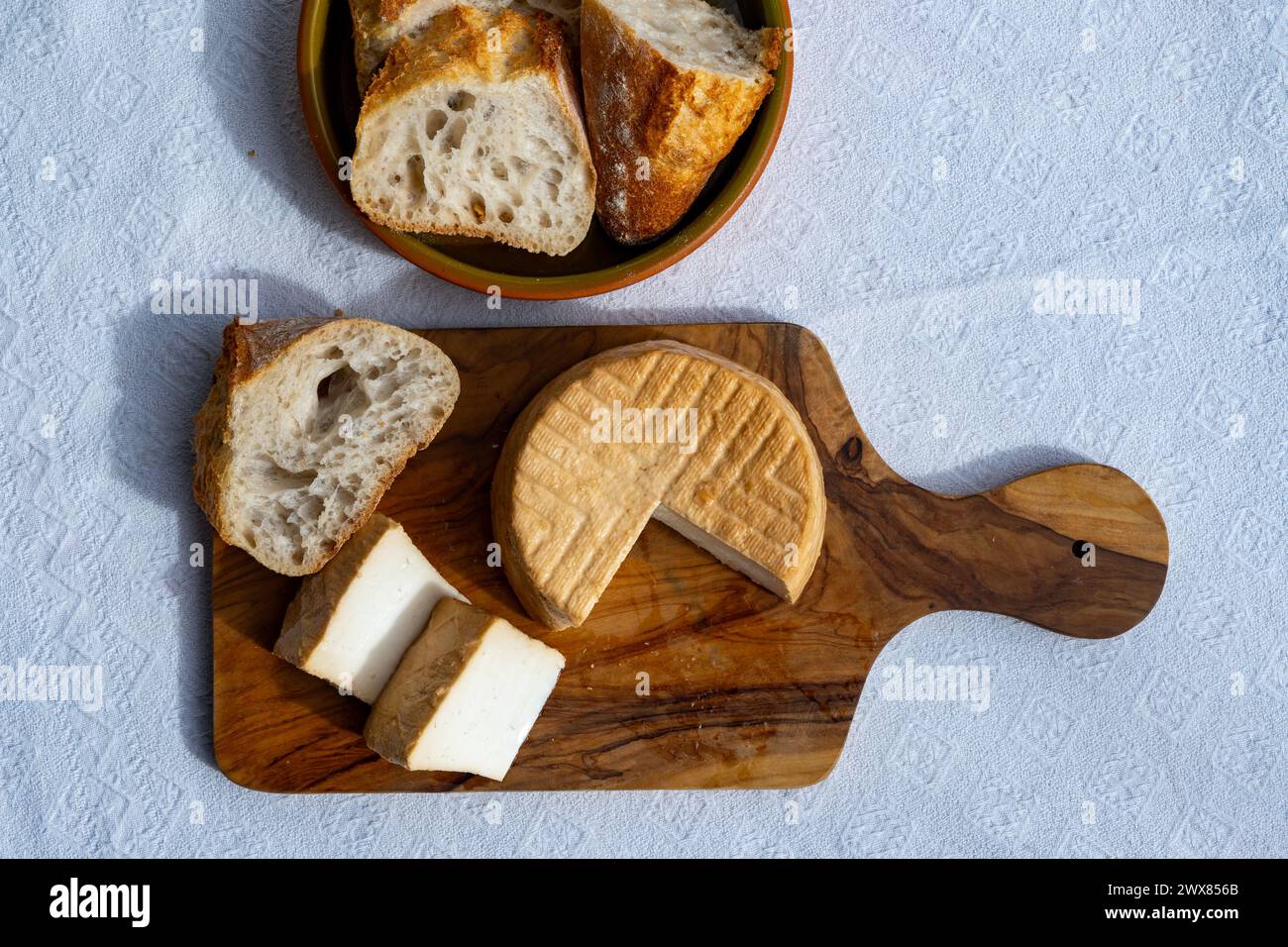 Cheese collection, piece of round fresh smoked Spanish goat cheese ...