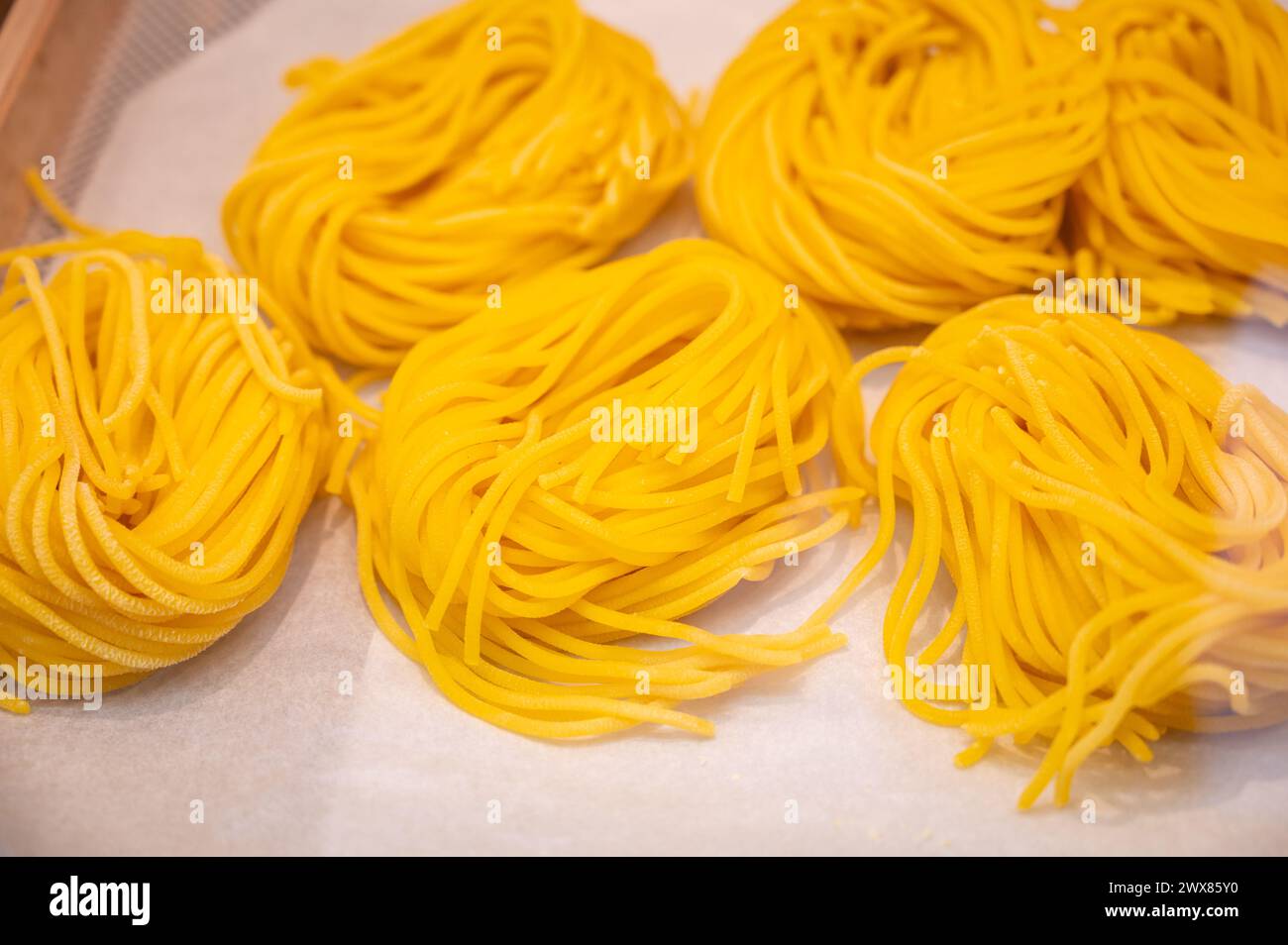 Italian food, fresh homemade yellow pasta with eggs ready to cook on ...