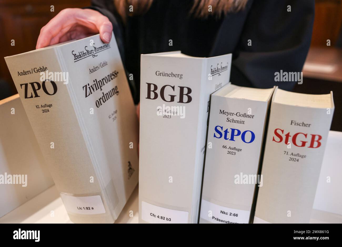 Cologne, Germany. 21st Mar, 2024. A judge in the courtroom holds the ...