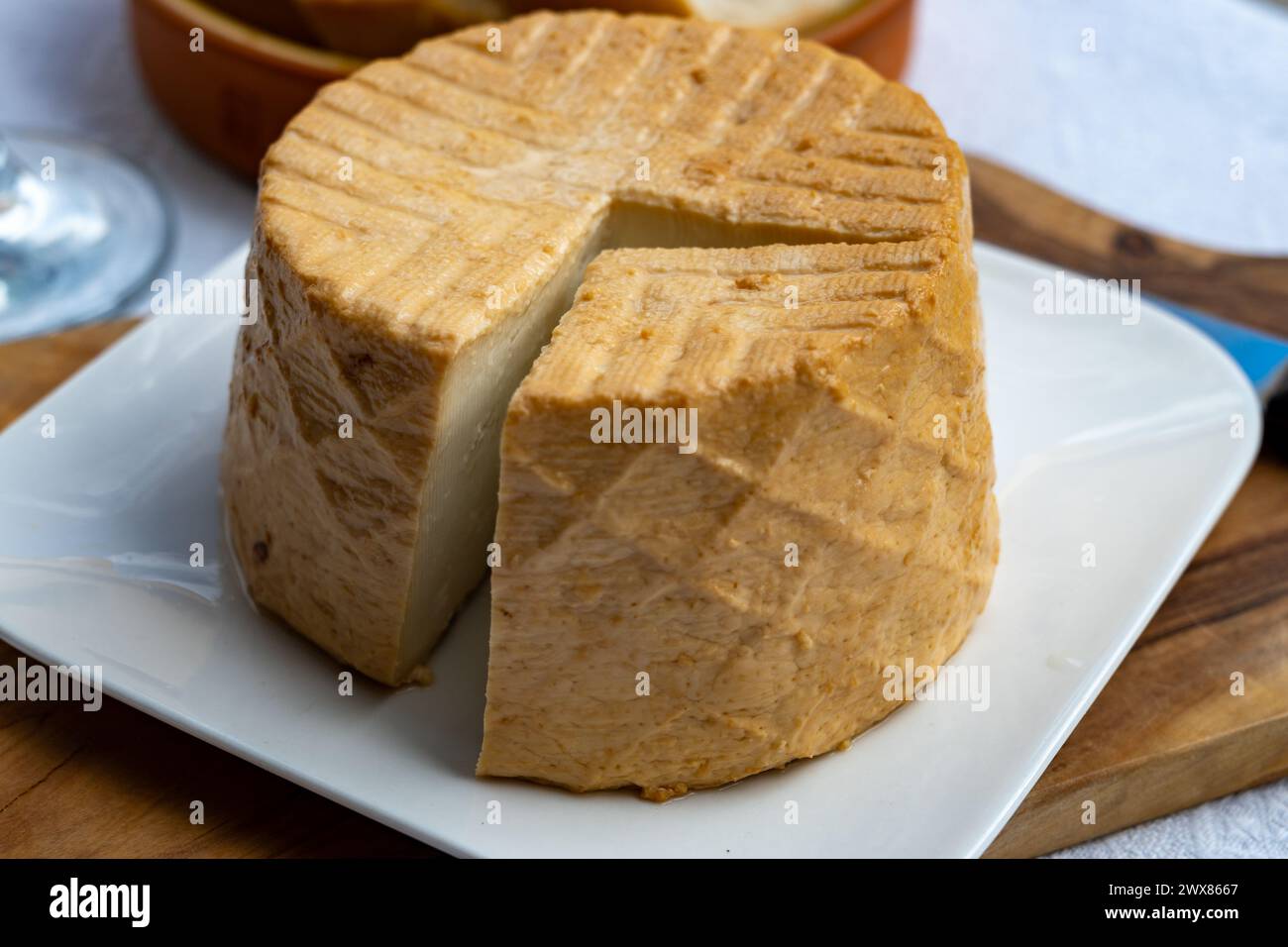 Cheese collection, piece of round fresh smoked Spanish goat cheese ...