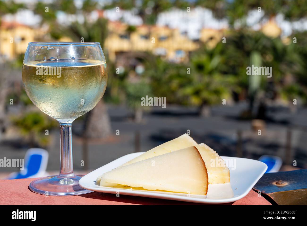 Spanish hard manchego, cow, sheep and goat cheese, glass of cold white ...