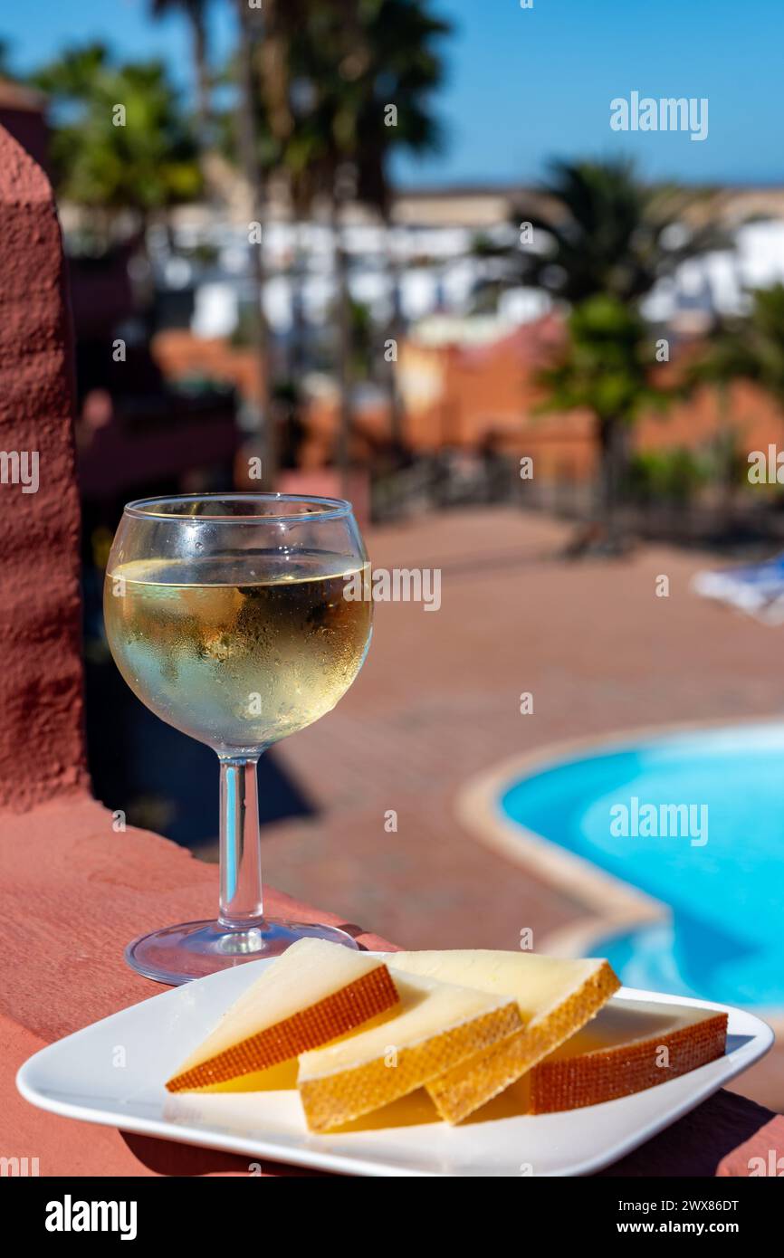 Spanish hard manchego, cow, sheep and goat cheese, glass of cold white ...