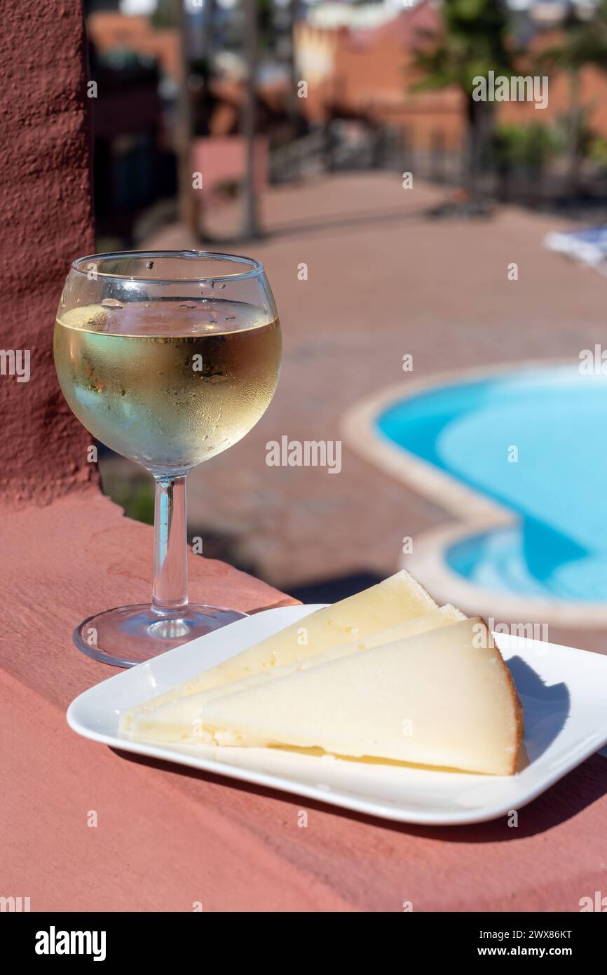 Spanish hard manchego, cow, sheep and goat cheese, glass of cold white ...