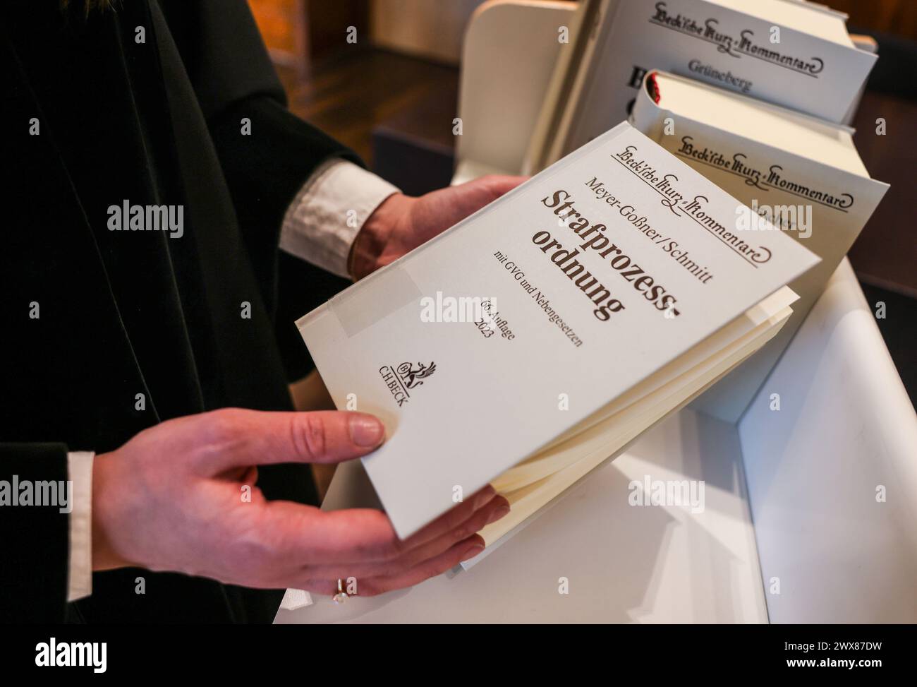 Cologne, Germany. 21st Mar, 2024. A judge holds the Code of Criminal ...