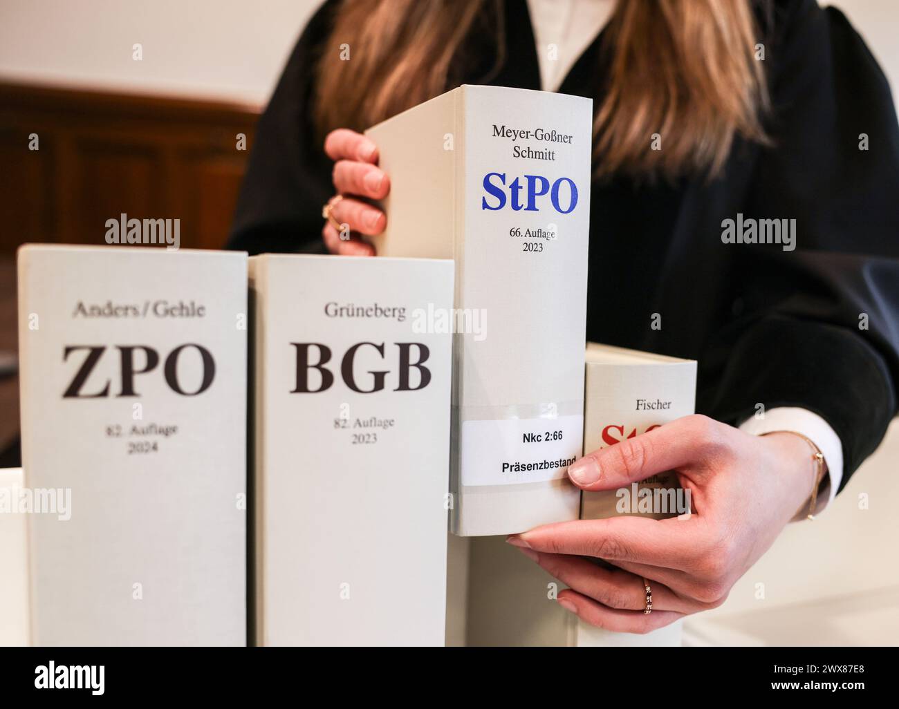 Cologne, Germany. 21st Mar, 2024. A judge holds the Code of Civil ...