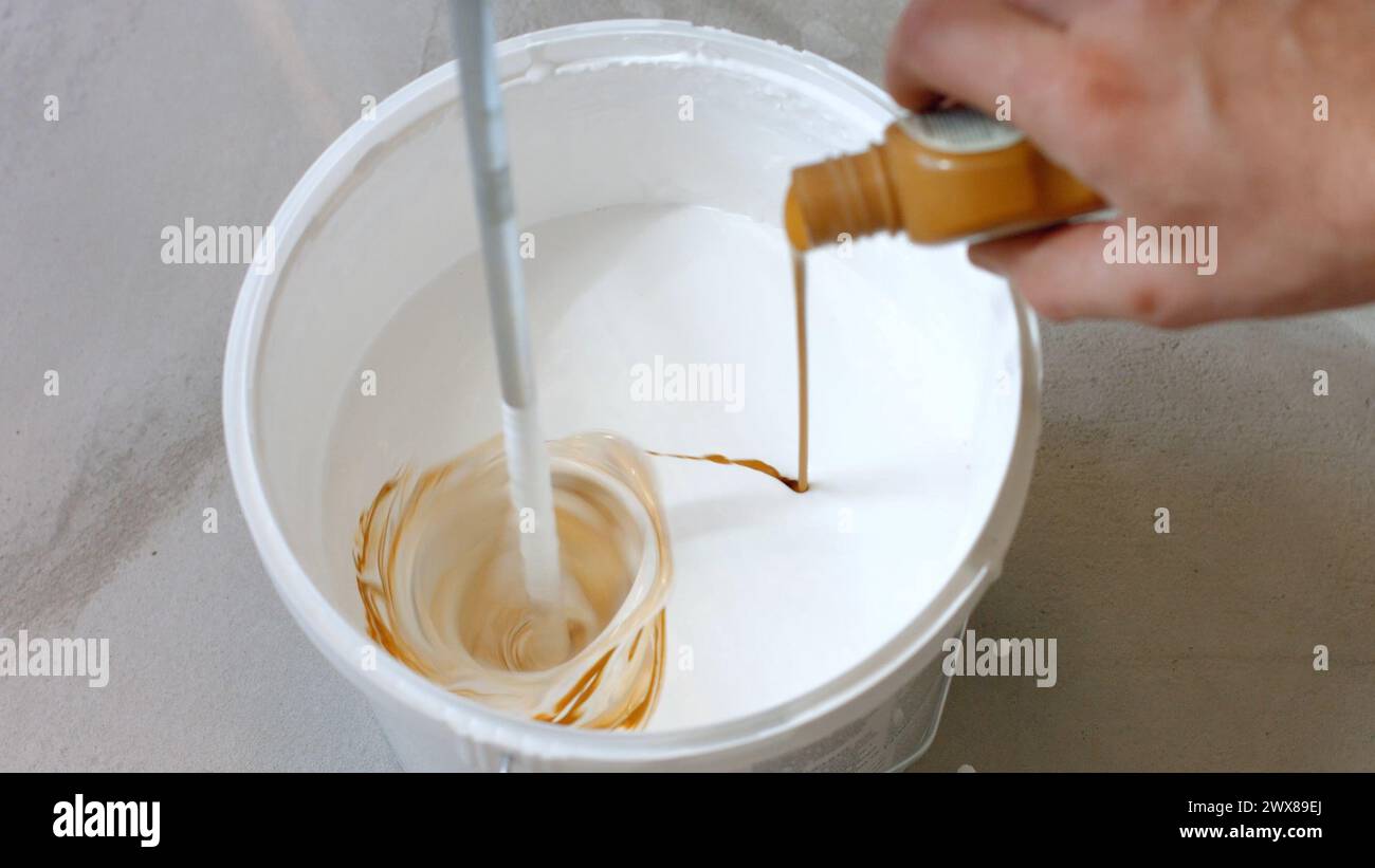 Dilution the paint mixer. Painting of white paint. Mixing the solution ...