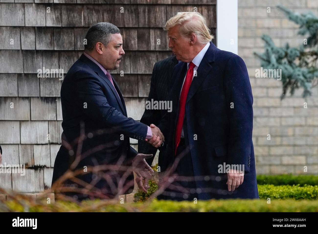 New York City Police Commissioner Edward A. Caban, left, shakes hands ...