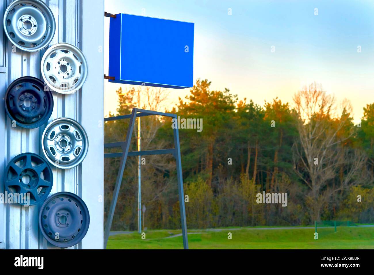 Car station. Metal car rims hanging on the wall Stock Photo - Alamy