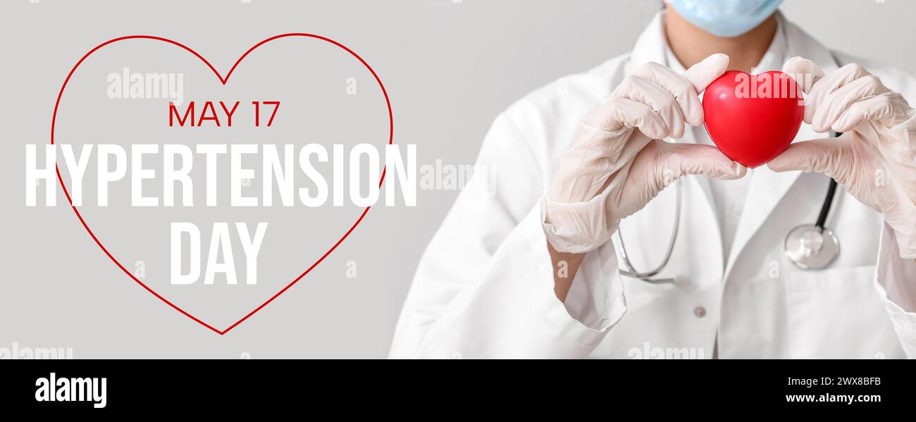 Doctor with red heart on light background. Banner for World ...