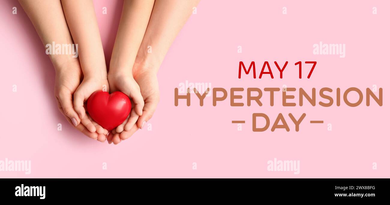 Hands of mother and child with red heart on pink background. Banner for ...