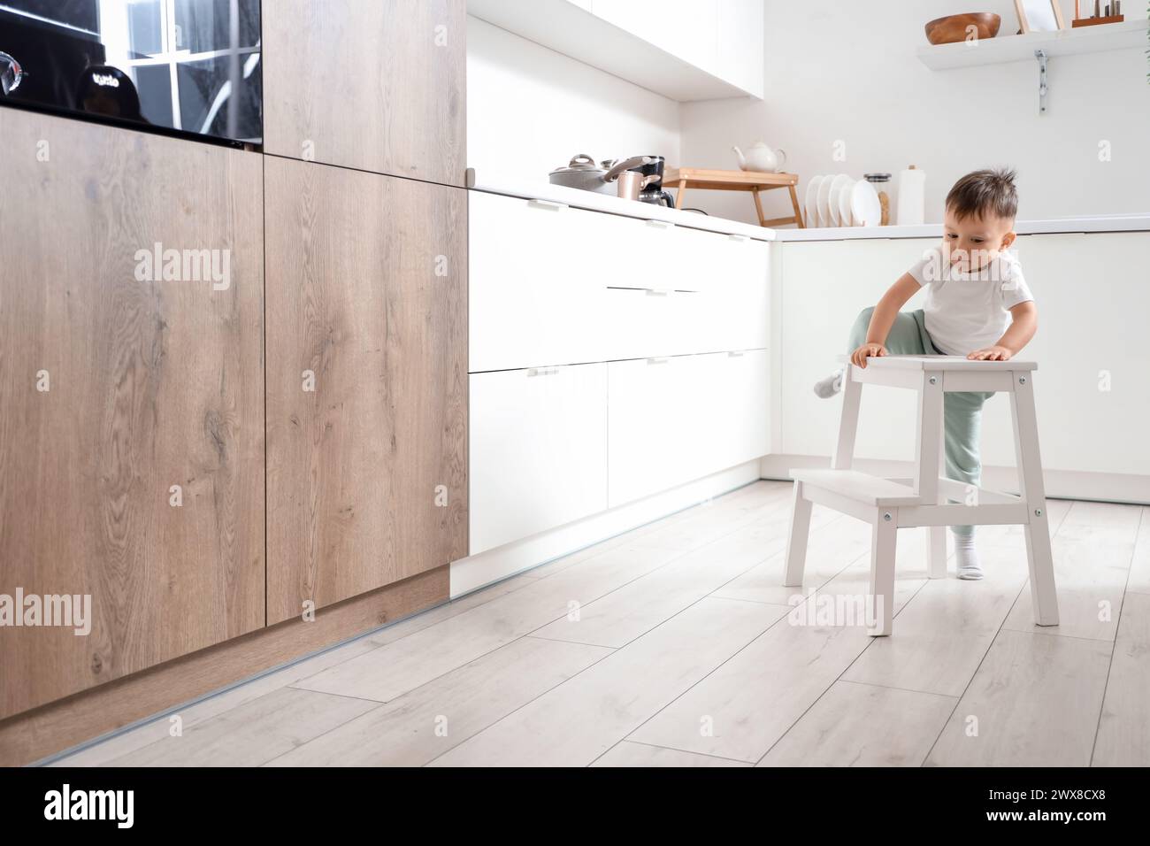 Boy climbing in kitchen hi-res stock photography and images - Alamy