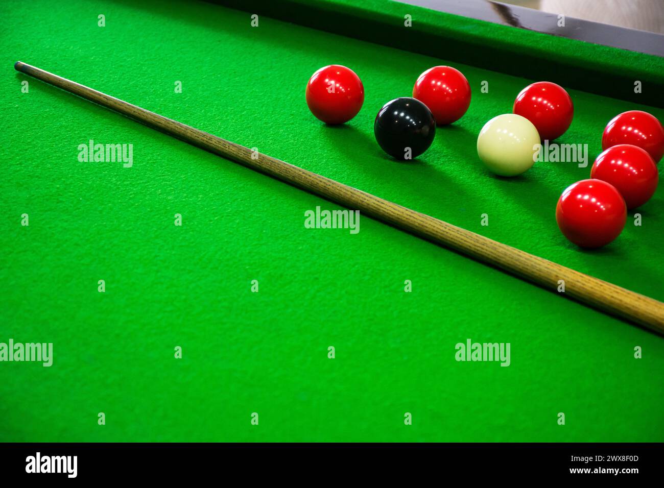 Billiard cues and balls on green table with red, white, and blue colors ...