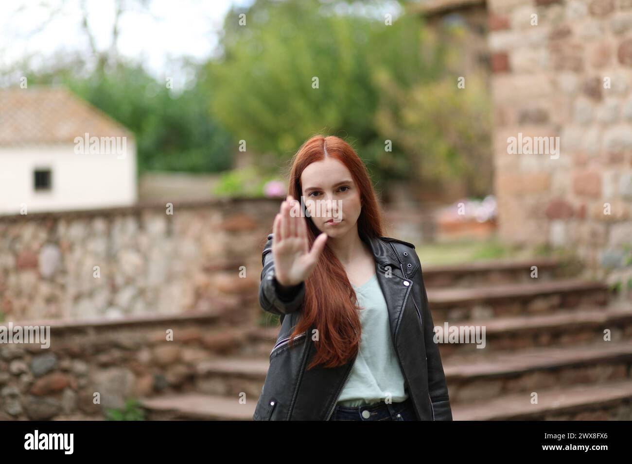 Woman with serious face makes the stop gesture with her hand raising ...