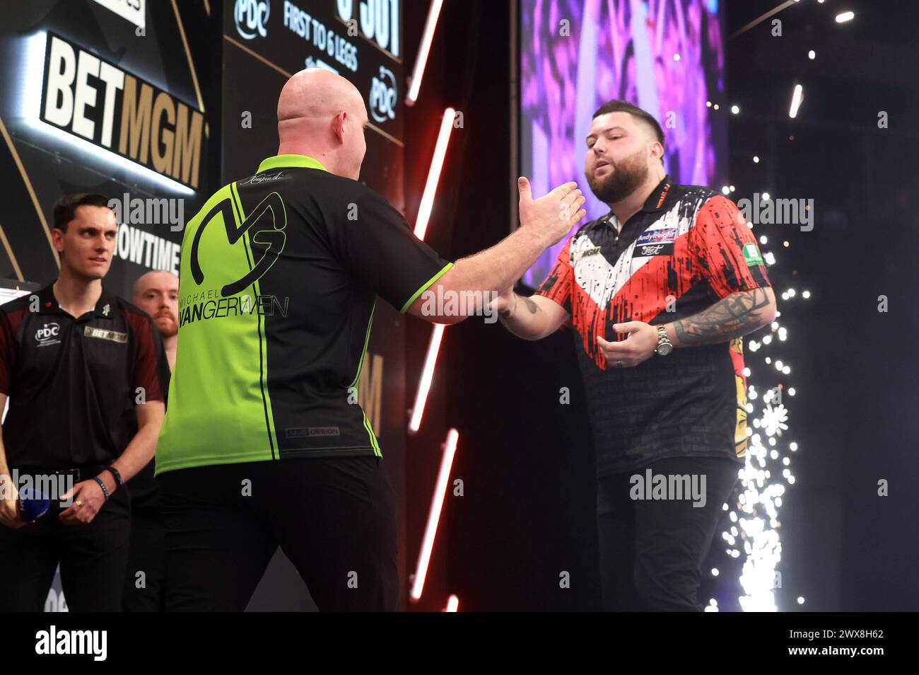 Michael van Gerwen (left) after victory in the quarter-final match ...