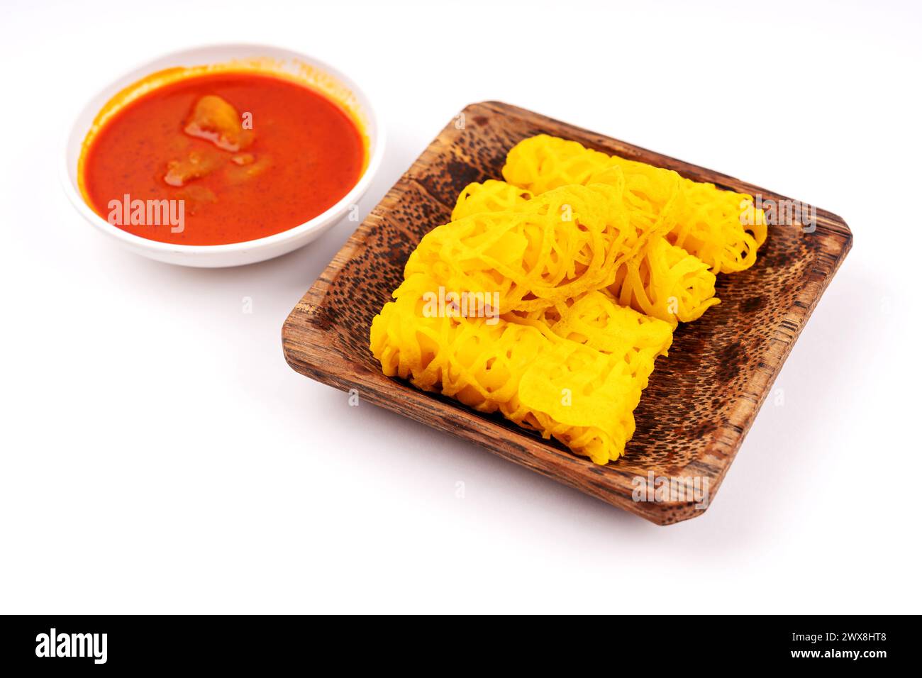 Close up of Roti Jala or Net Bread and curry sauce on white background ...