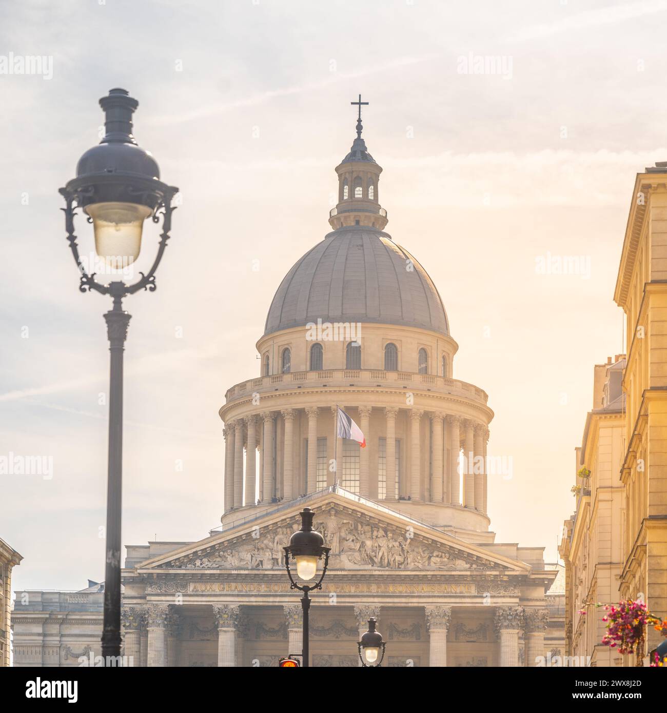 The Pantheon in Paris bathed in the warm glow of a setting sun, with ...