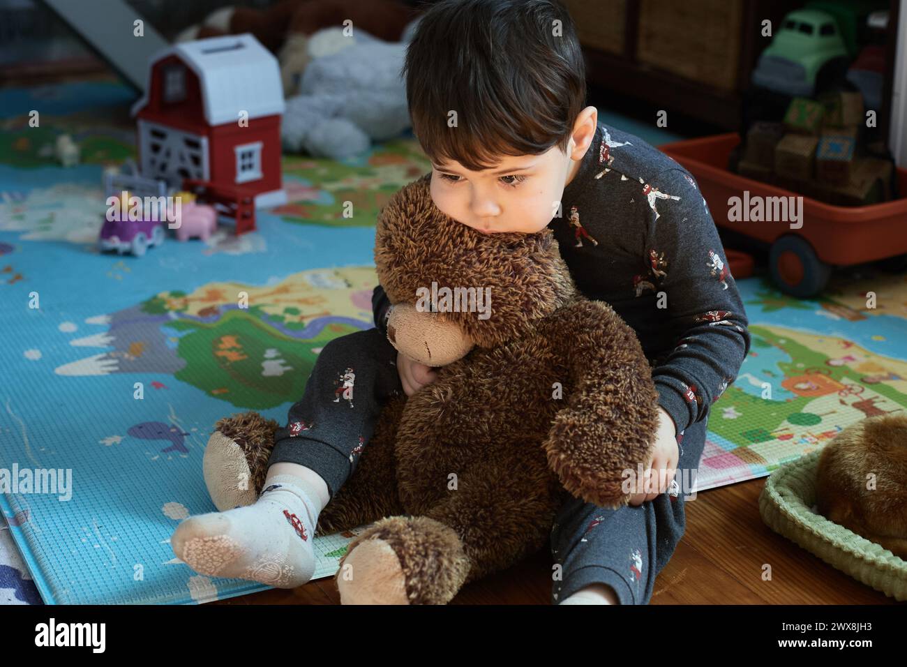 Boy hugging teddy bear hi-res stock photography and images - Alamy