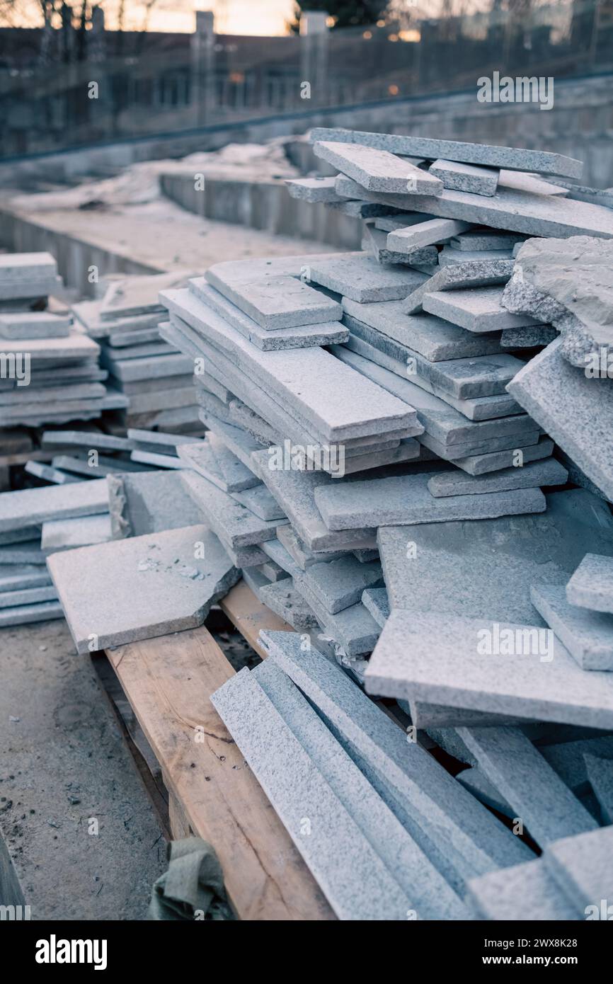 Piles of granite tiles ready for installation at a new building site at ...