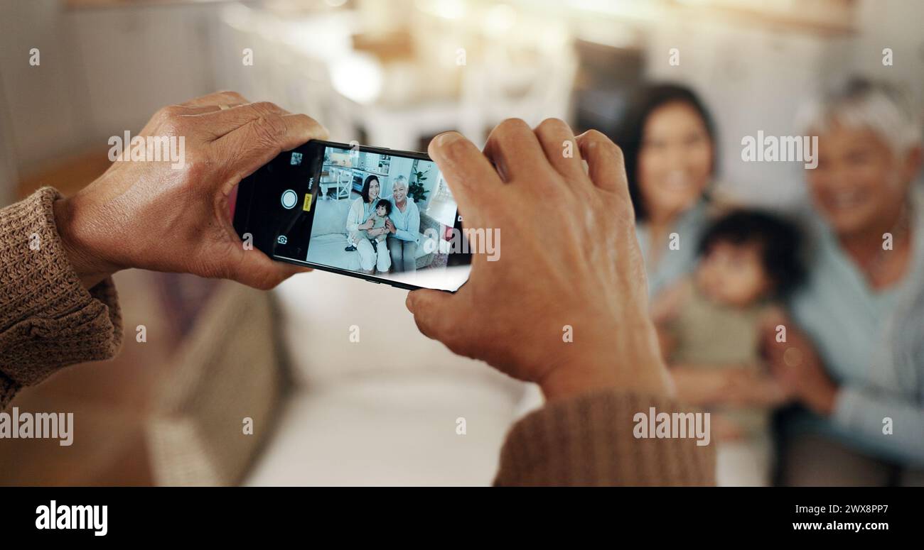 Phone screen, hands and picture of family in living room with smile ...