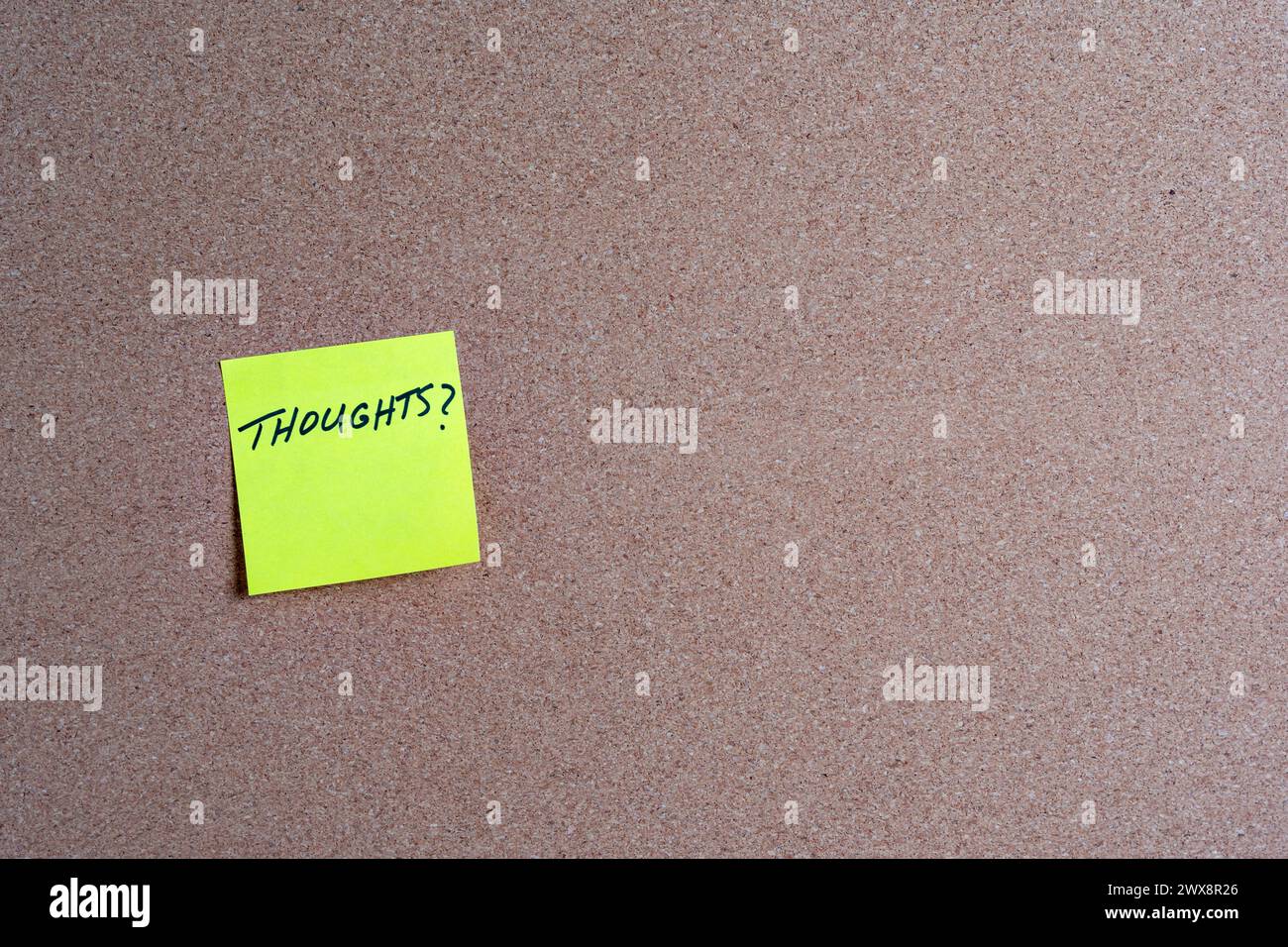 The word Thoughts on a yellow sticky note posted on a corkboard Stock ...