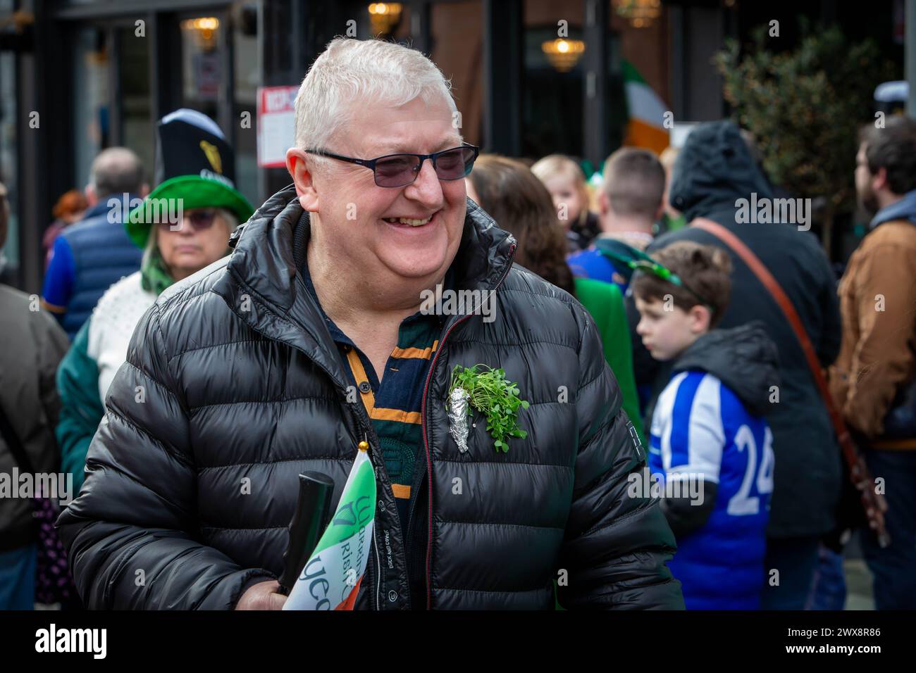 Silver haired male laughs during the 2024 Warrington St Patrick's Day ...