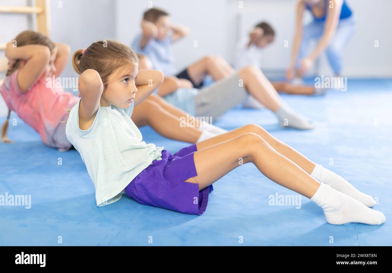 Children train their abdominal muscles during self-defense classes in ...