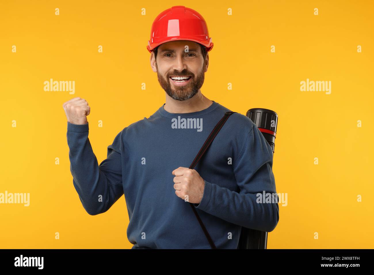 Architect in hard hat with drawing tube on orange background Stock ...