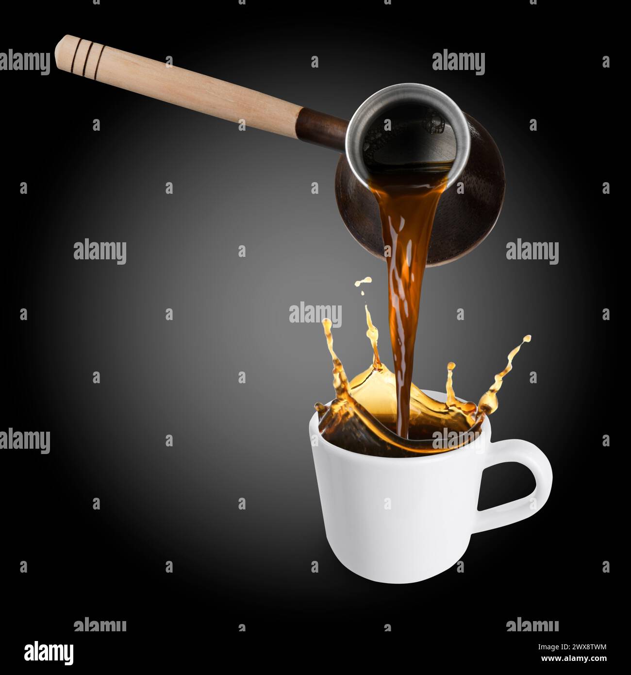 Pouring freshly brewed aromatic coffee from turkish pot into cup ...