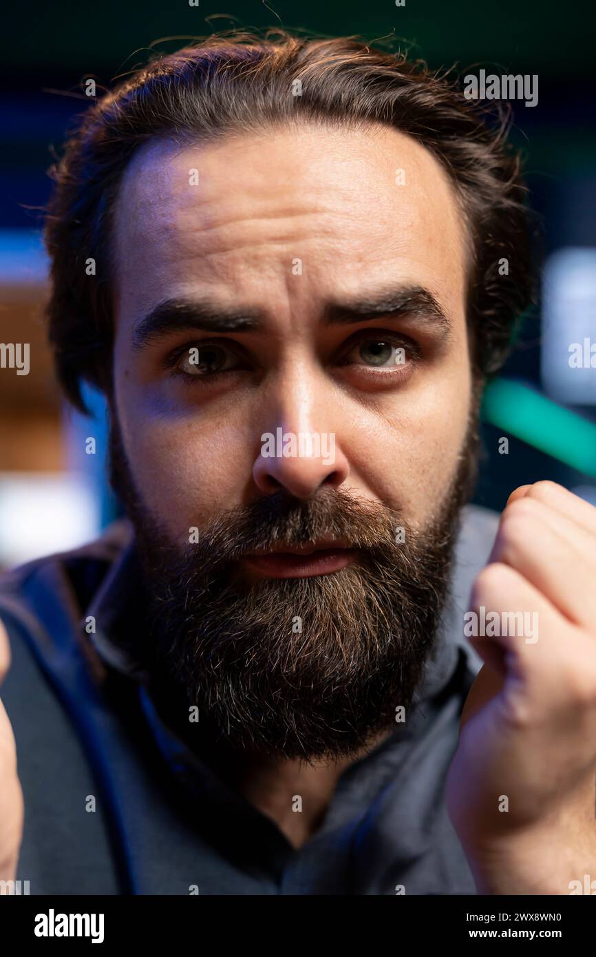 Close up shot of man in apartment watching horror movie broadcasted on ...