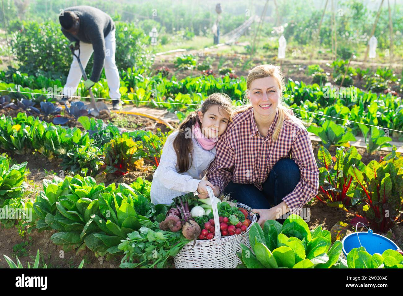 Portrait of a young woman with a teenage girl in the vegetable garden ...