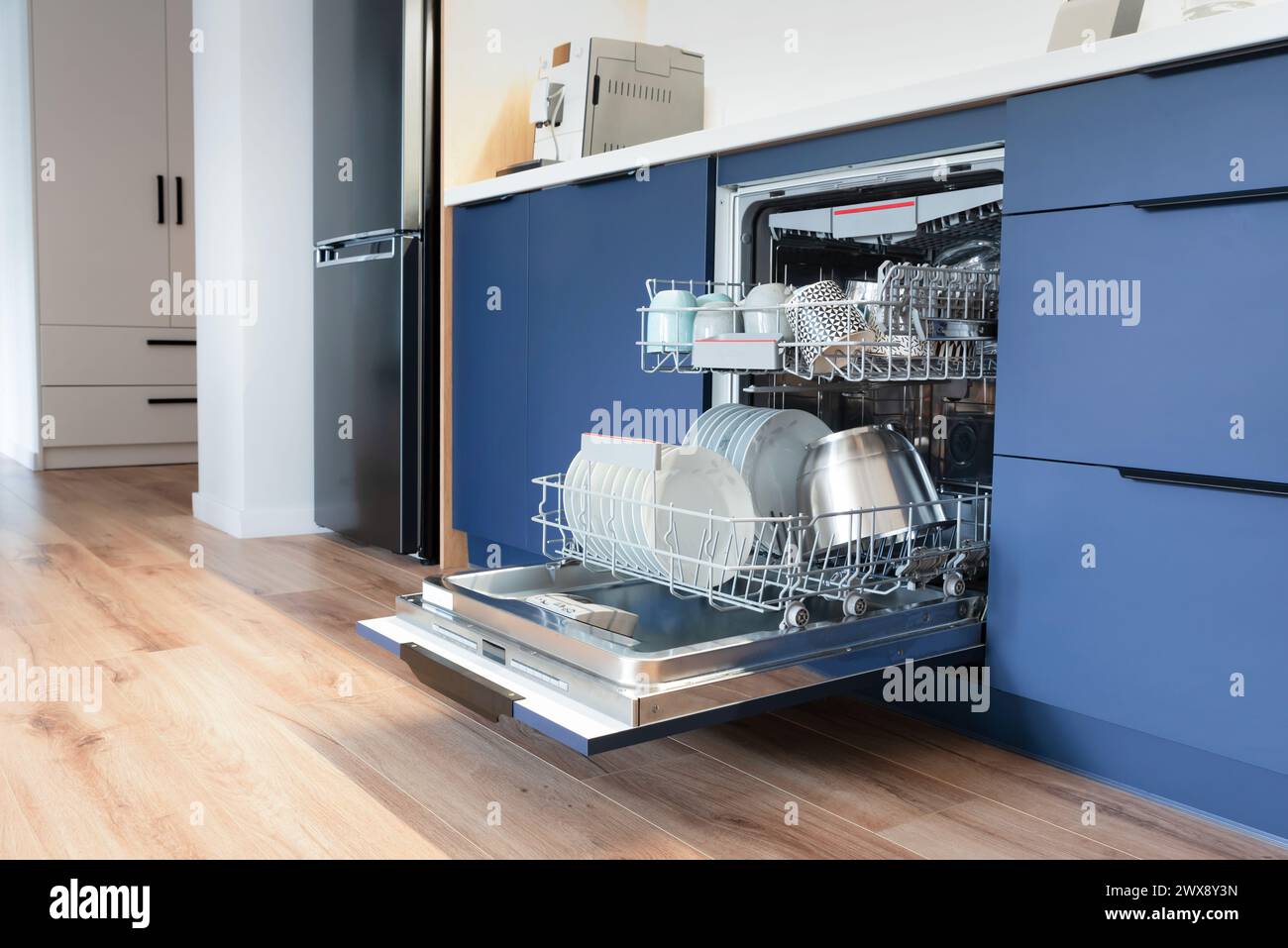 Dishwasher in modern blue kitchen. Perfectly washing dishes Stock Photo ...
