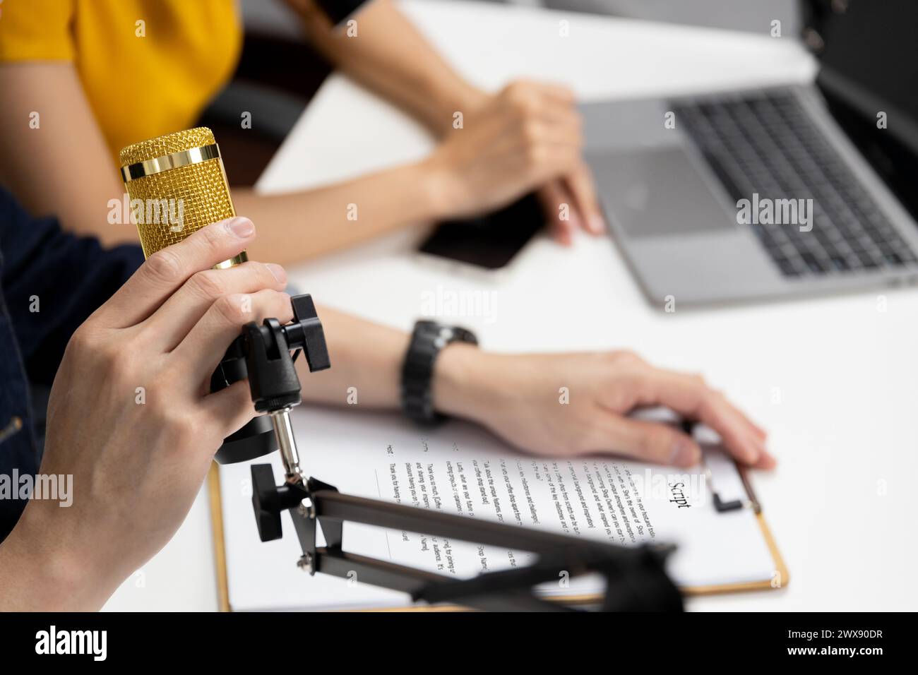 Selective focusing on hands with writing script note of radio ...
