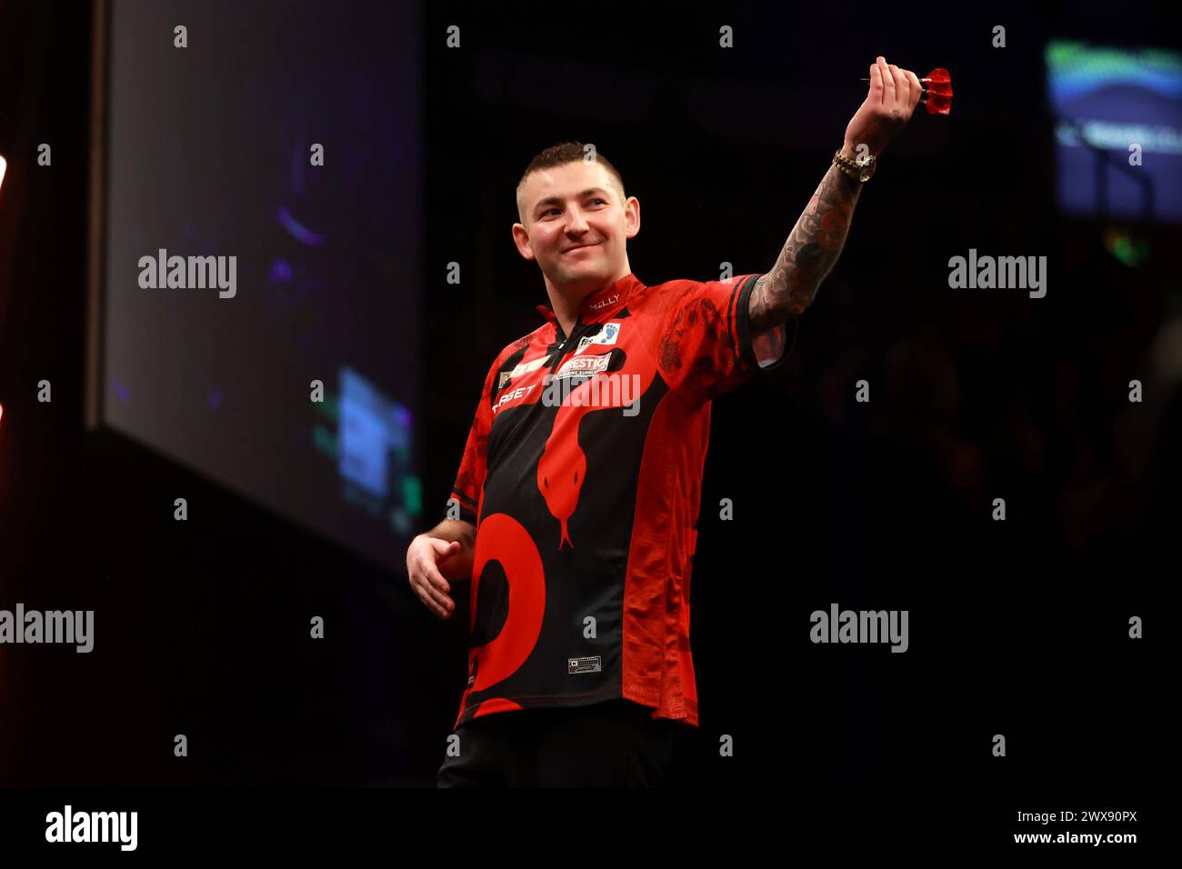 Nathan Aspinall celebrates winning a leg in the final against Luke ...