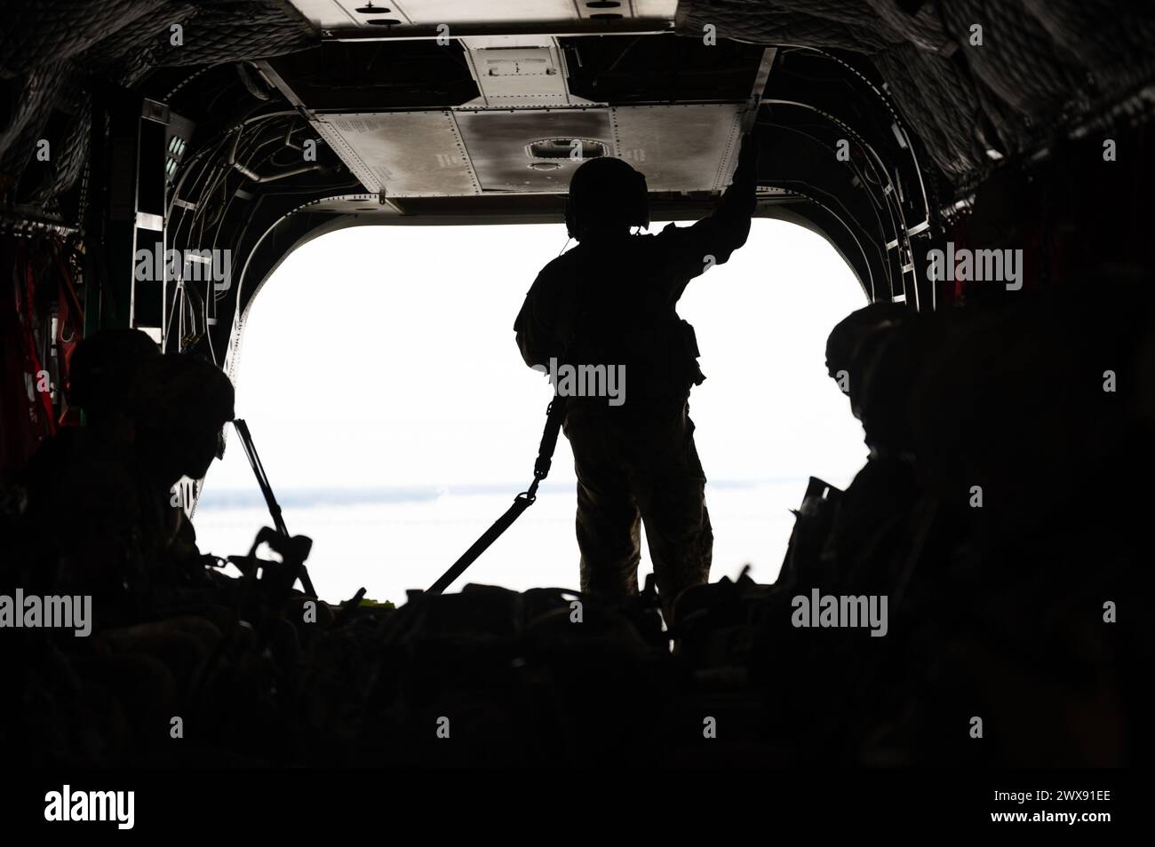U.S. Soldiers participating in the Best Squad Competition ride in a CH ...