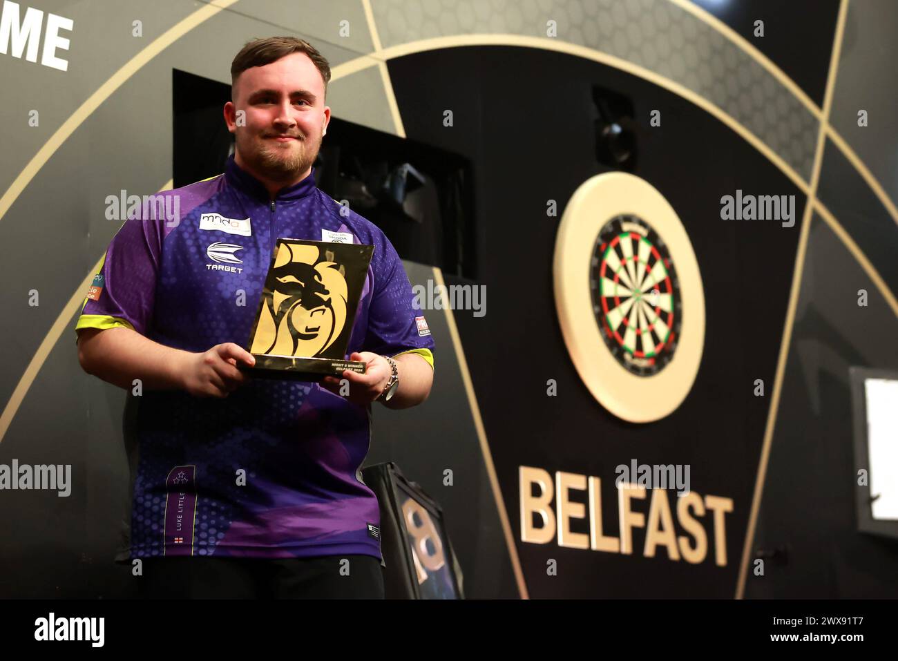 Luke Littler celebrates with the trophy after victory in the final ...
