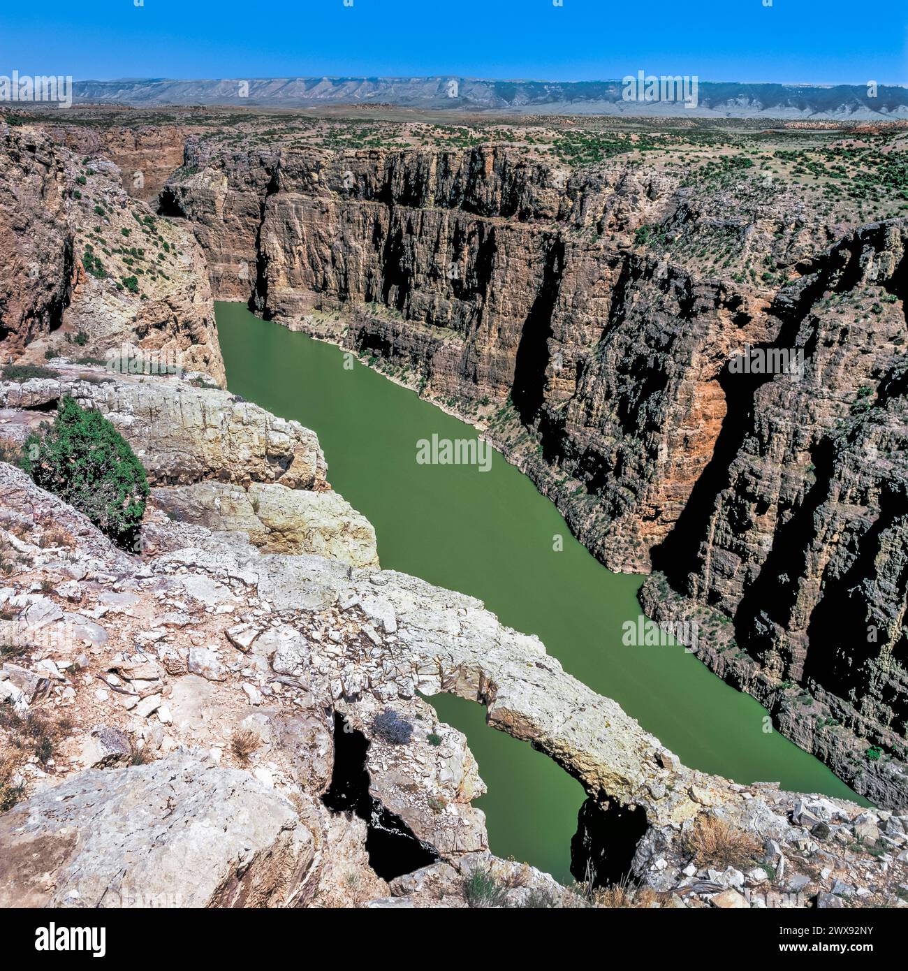 arch in the cliff wall above bighorn canyon in bighorn national ...