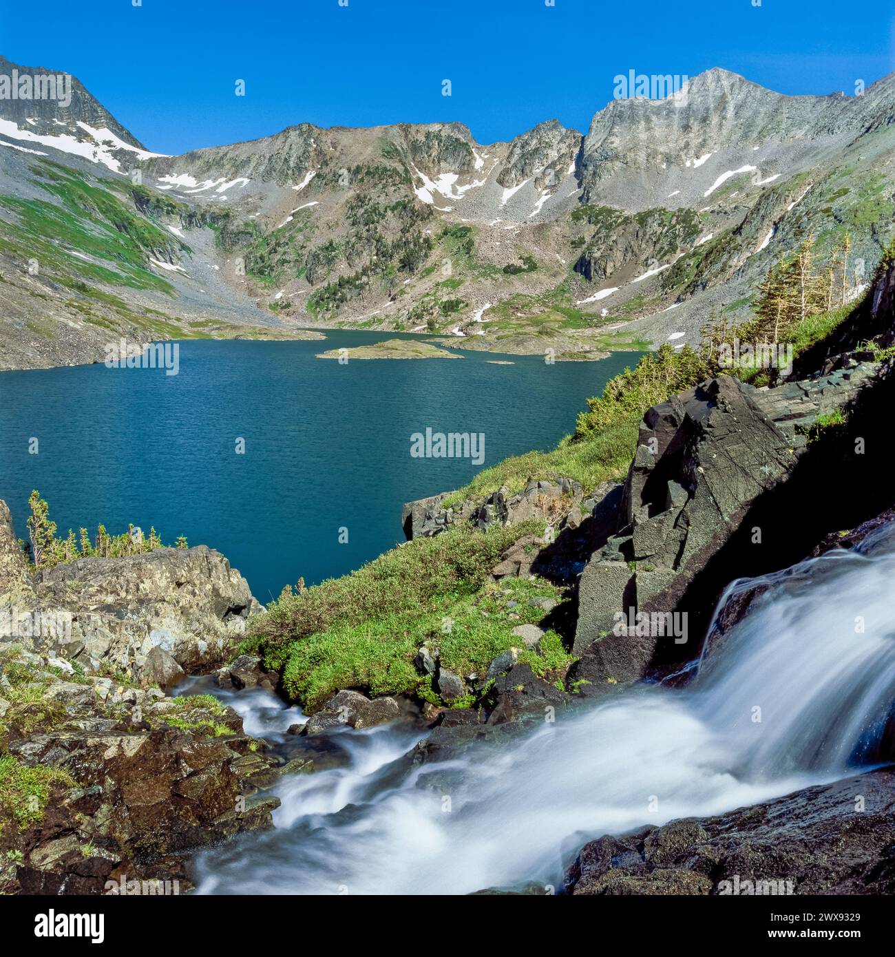 waterfall cascading to rock lake in the crazy mountains near clyde park ...