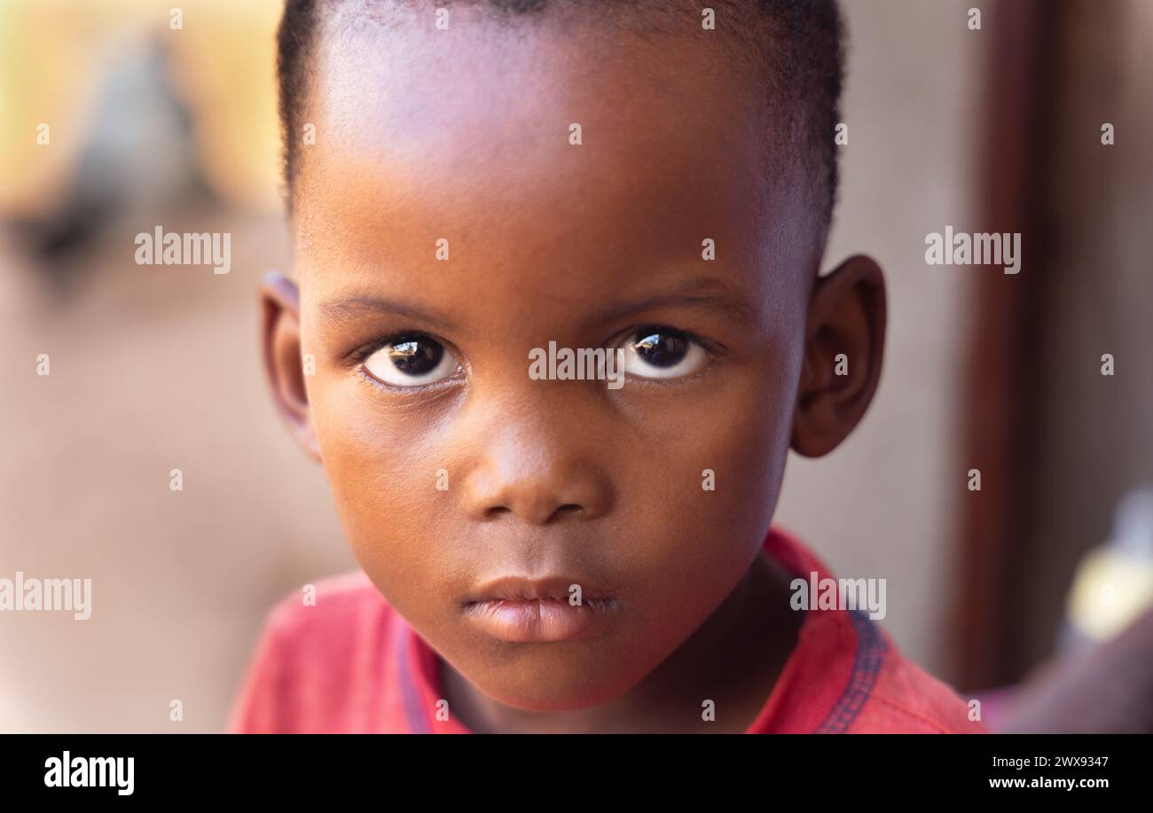 closeup portrait of a single african kid playing in the yard , african ...